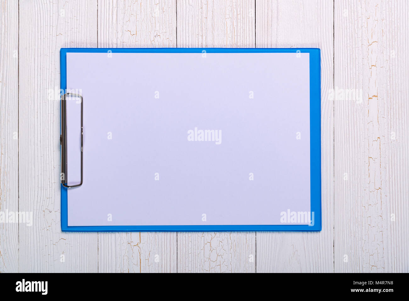 clipboard with blank white paper sheet on wood table top view with copy ...