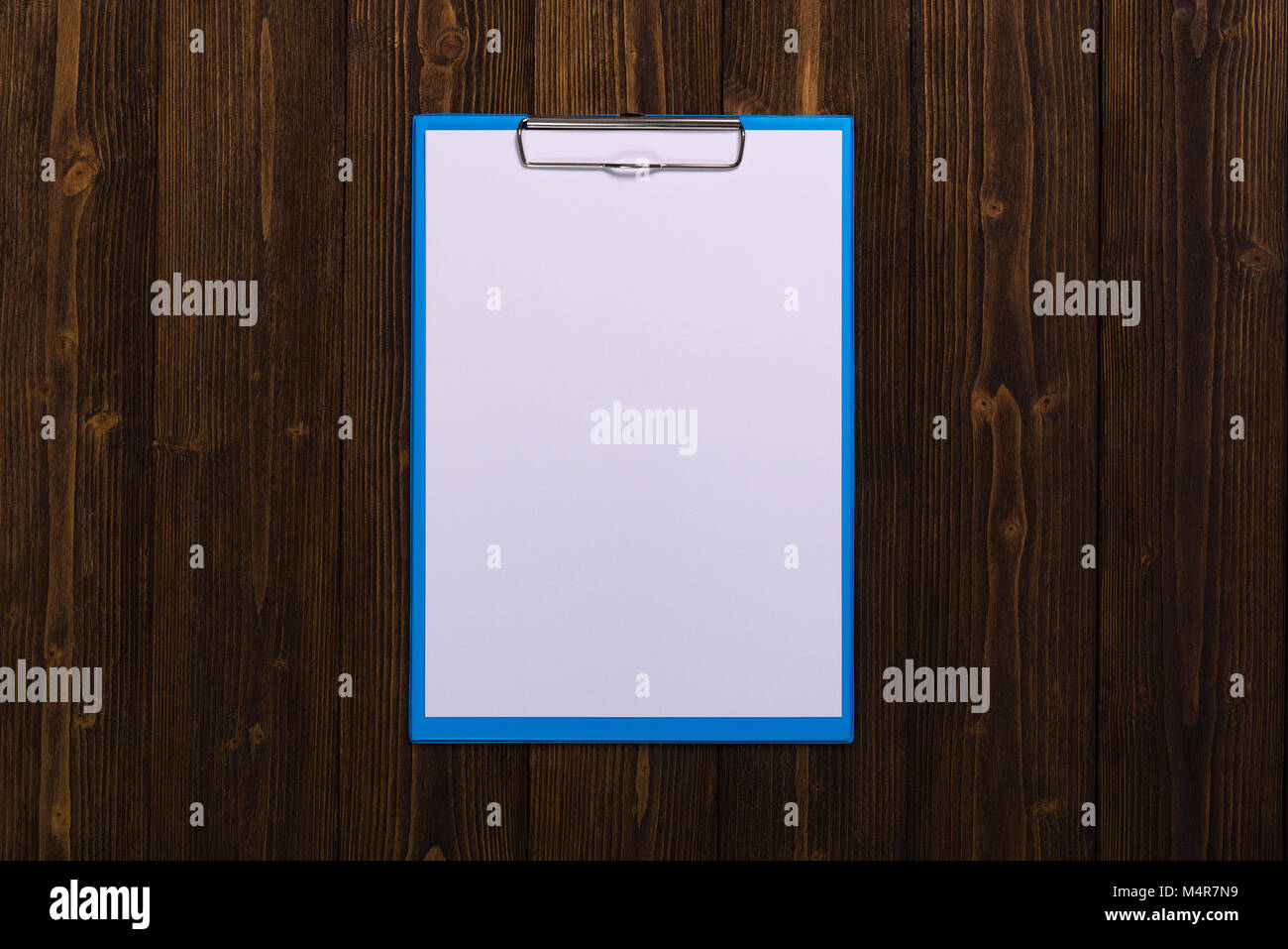 clipboard with blank white paper sheet on wood table top view with copy ...