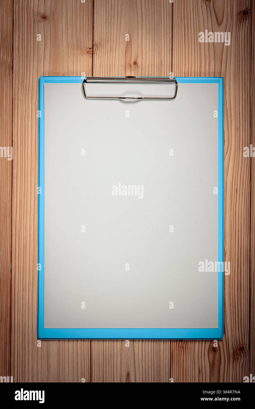 clipboard with blank white paper sheet on wood table top view with copy ...