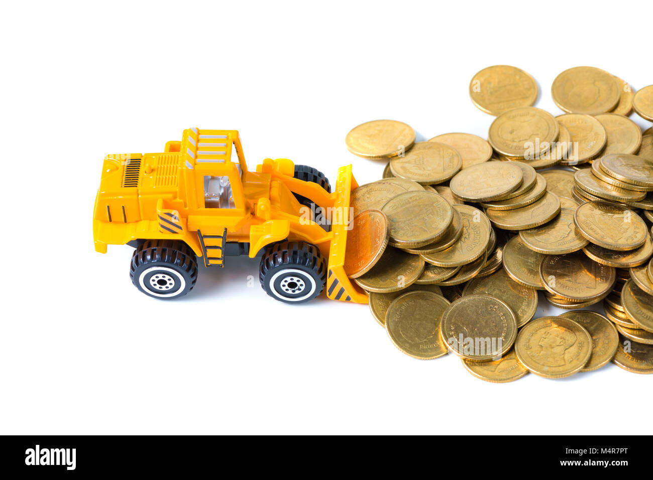 Mini bulldozer truck loading stack coin with pile of gold coin ...