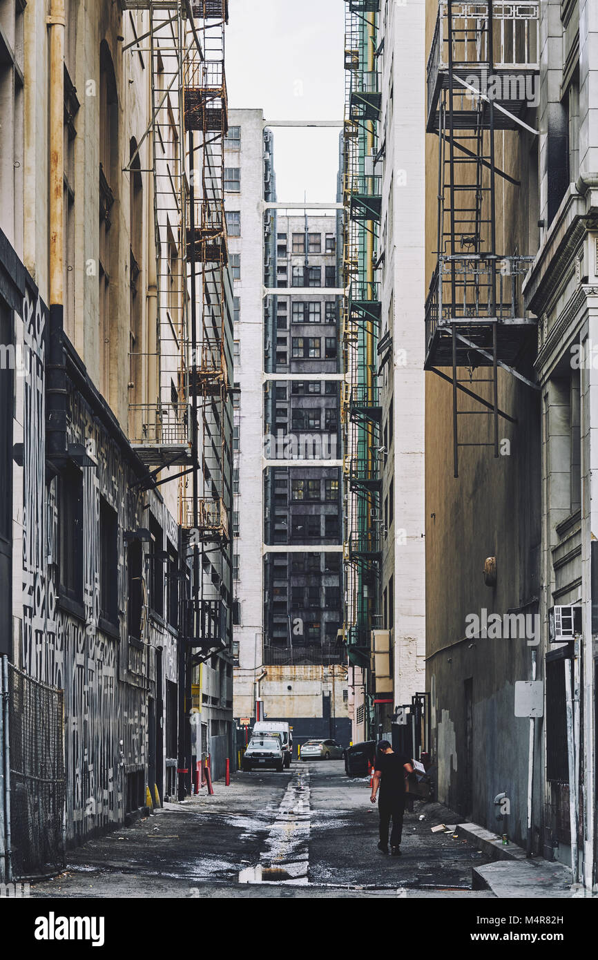 Alleyway with man walking Stock Photo - Alamy