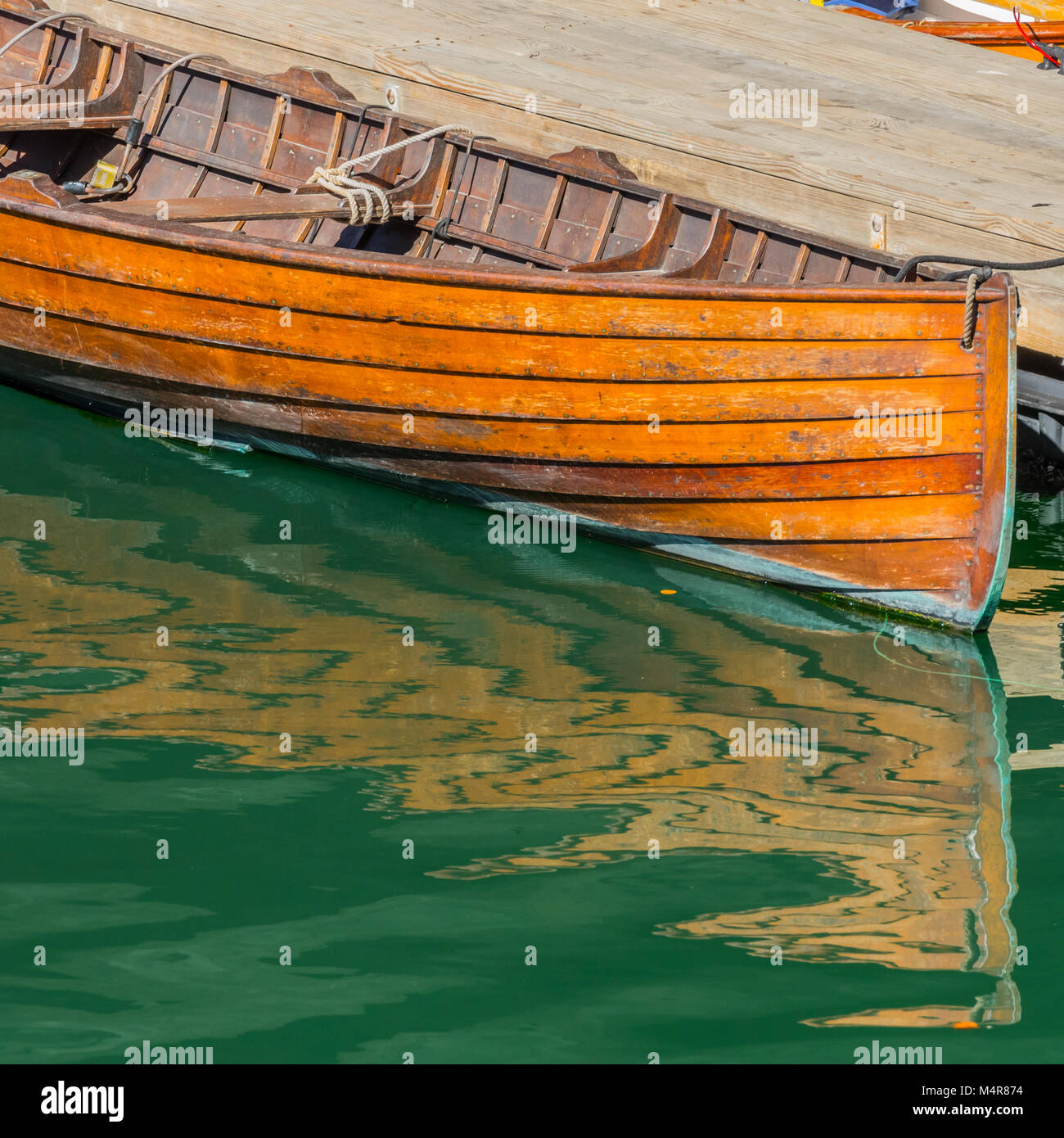 Old Wooden Boat and Green Water in harbor marina Stock Photo - Alamy
