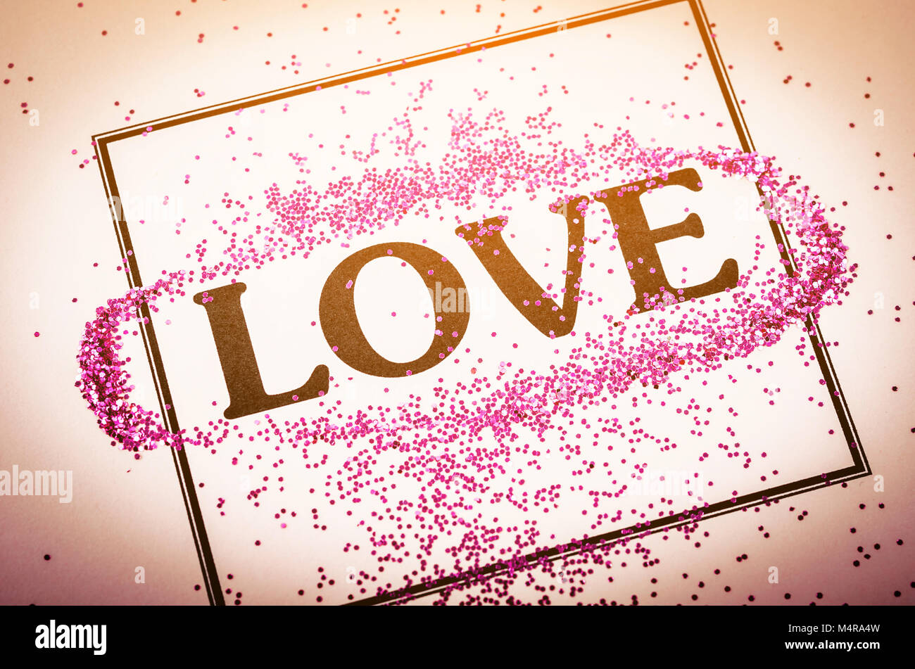 LOVE word with glitter in frame on beautiful paper background ...