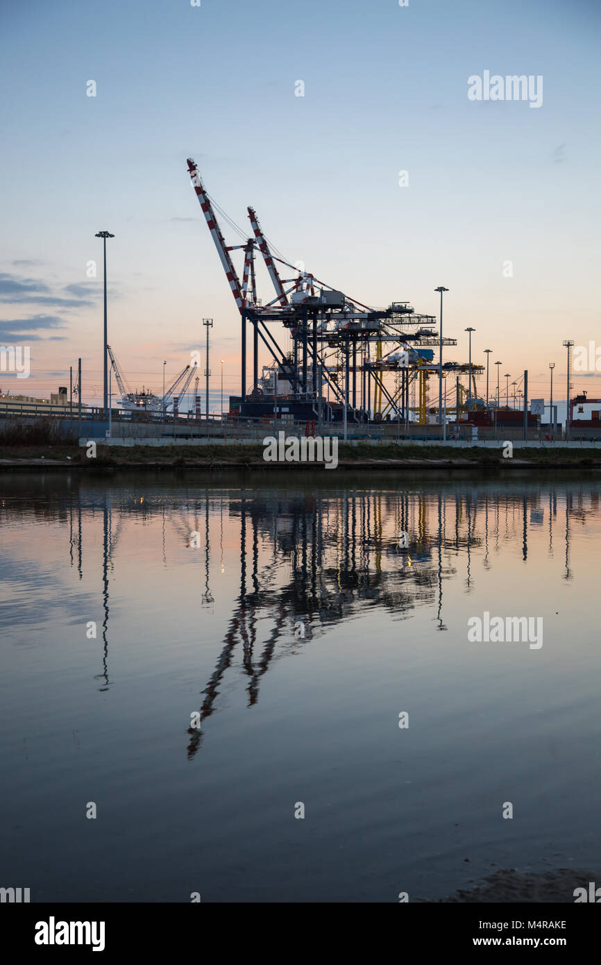 Container Terminal, Shipyard and Cranes at Sunset and Their Reflection ...
