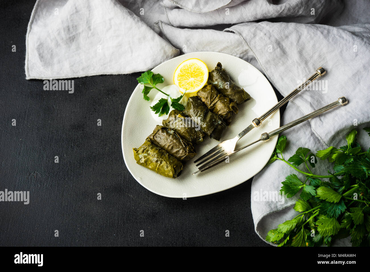Traditional georgian dolma in grape leaves on rustic wooden table with ...