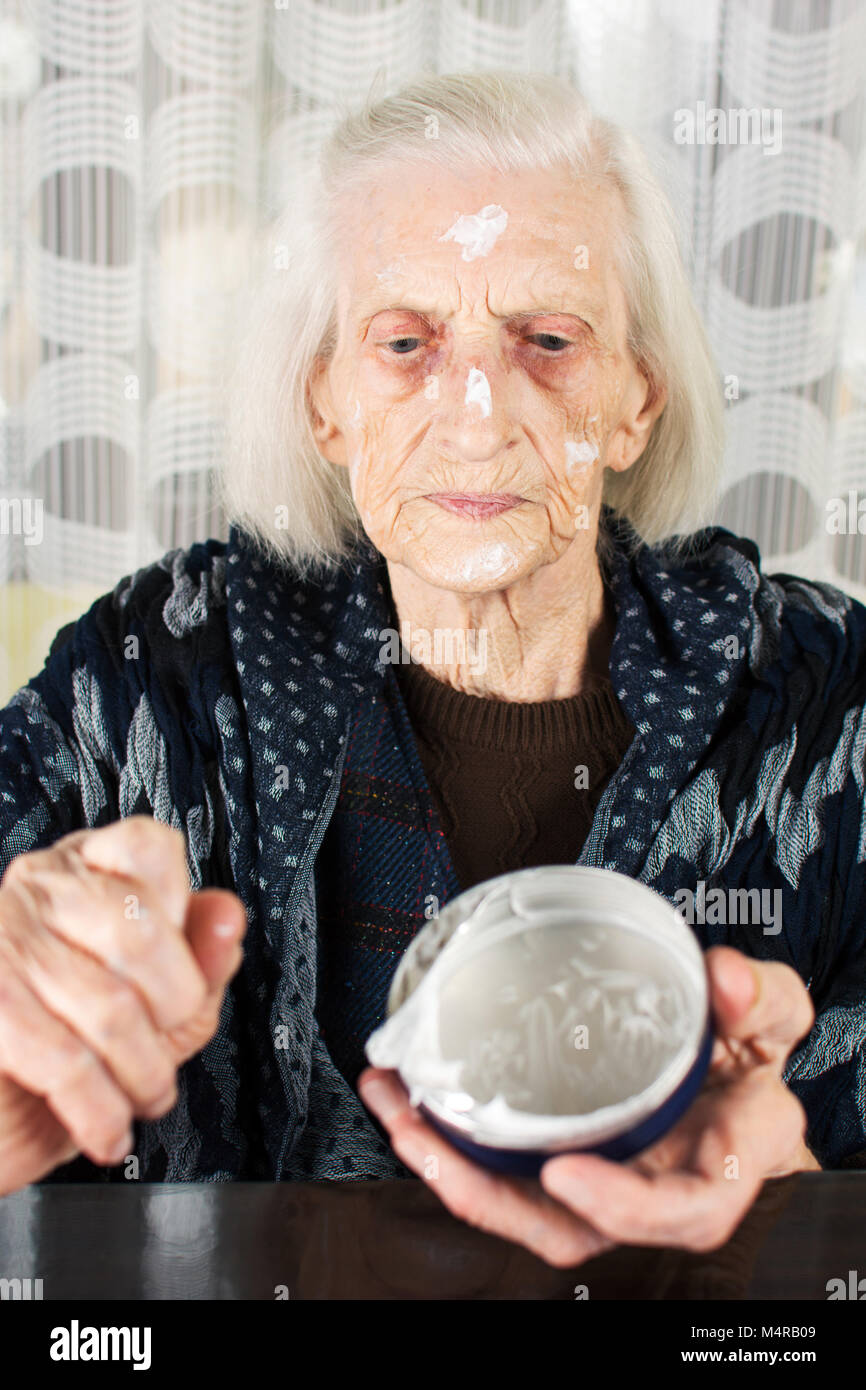 Senior woman apply face cream hi-res stock photography and images - Alamy