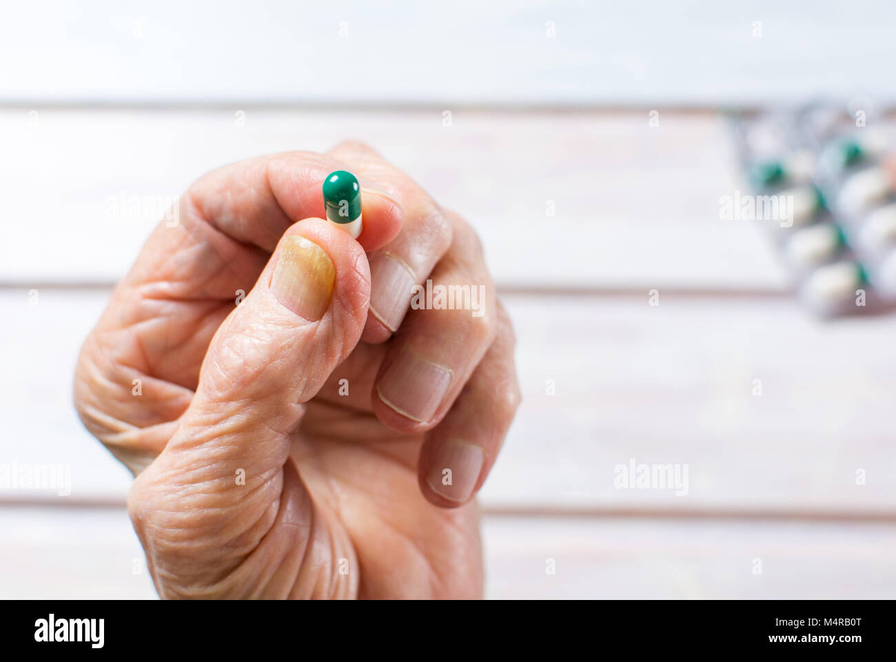 Female hand holding pills hi-res stock photography and images - Alamy