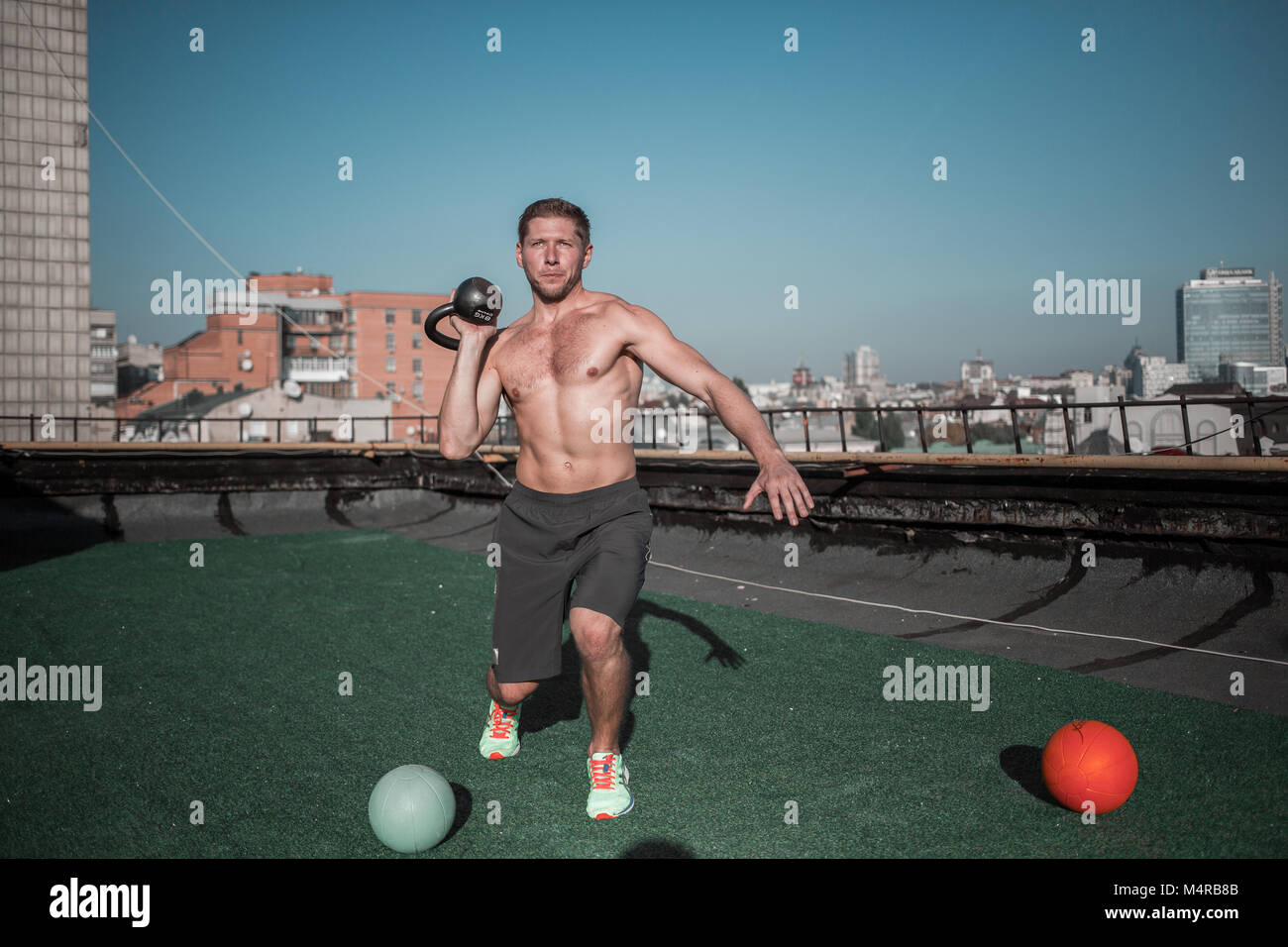 Man practicing crossfit exercises with weight Stock Photo - Alamy