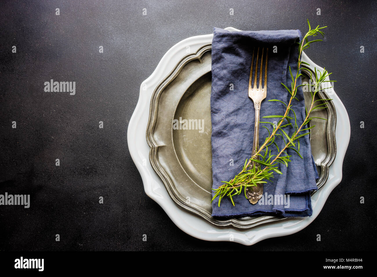 Summer time table setting with fresh rosemary spice on rustic ...