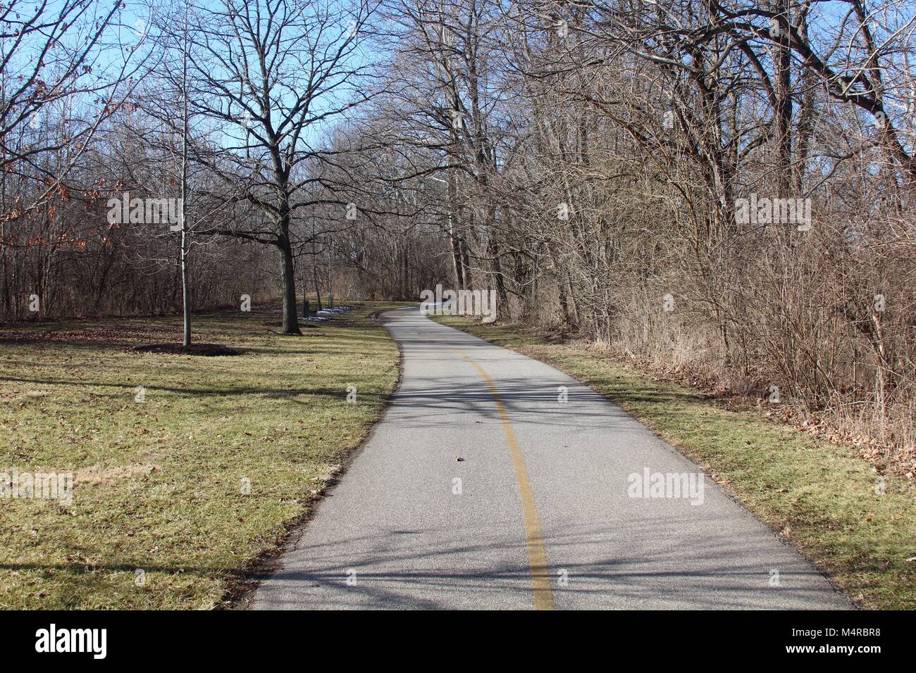 A sunny day at the park with the trails and signs along the way Stock ...