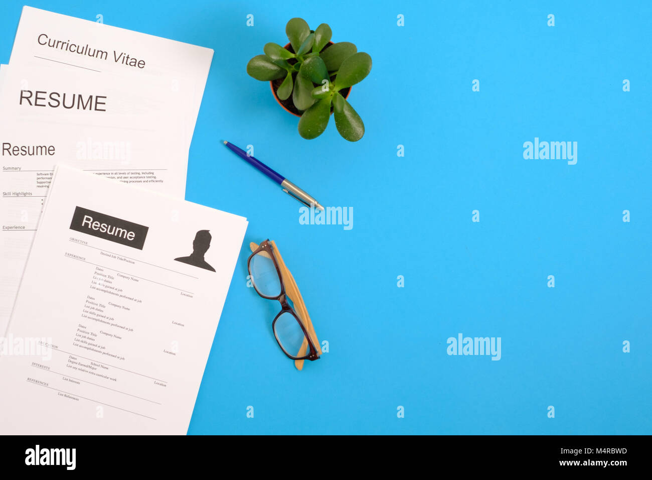 Pile of cv papers application form on a blue desktop.Top view Stock ...