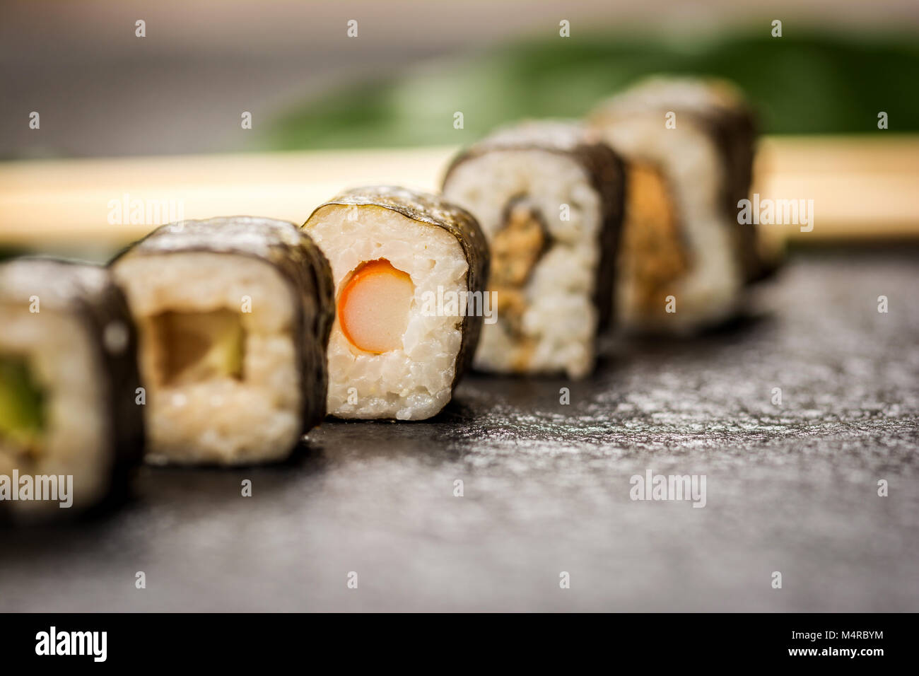 Traditional japanese sushi rolls hosomaki on stone desk Stock Photo - Alamy