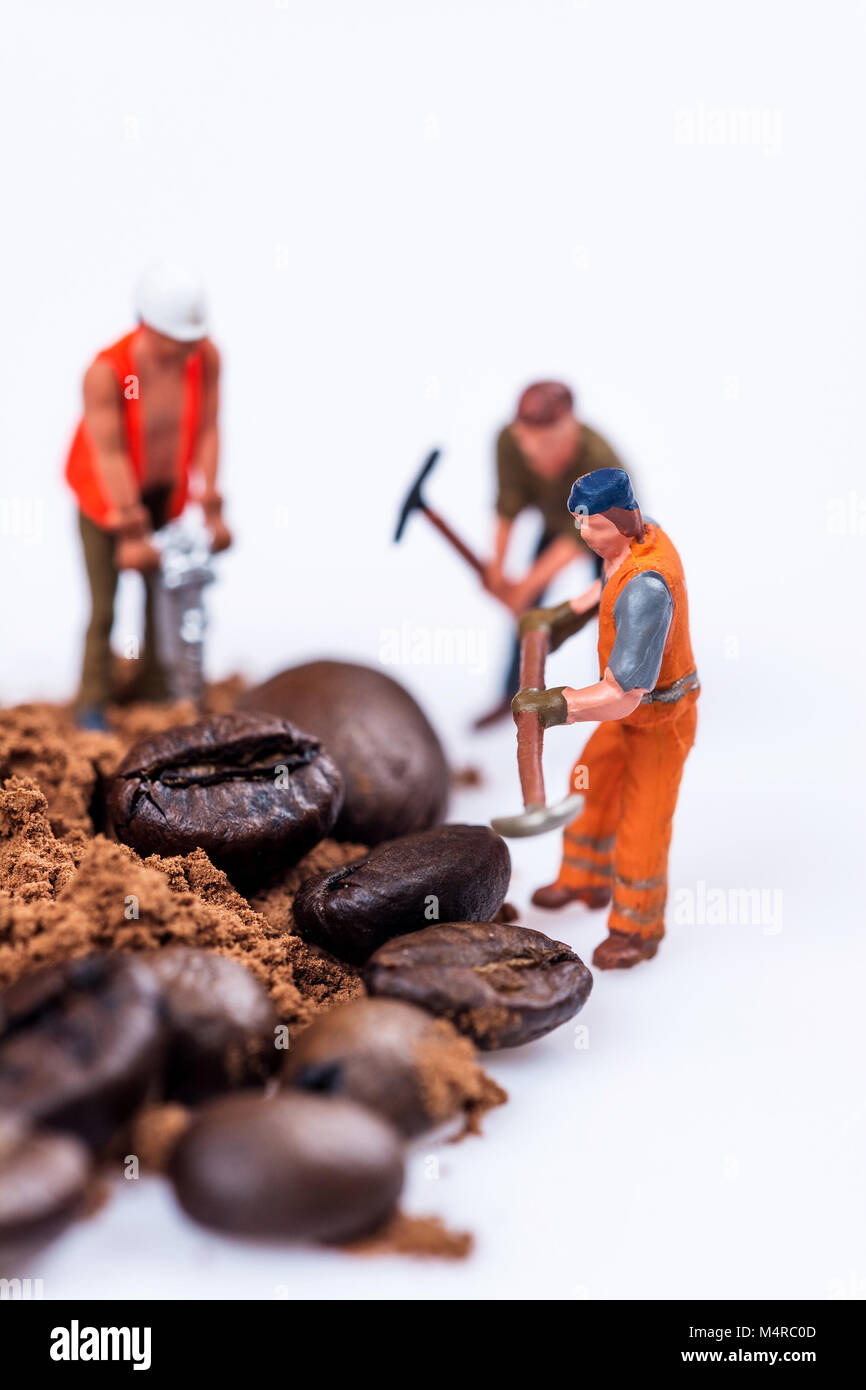 Miniature figures working on coffee macro photography on white ...