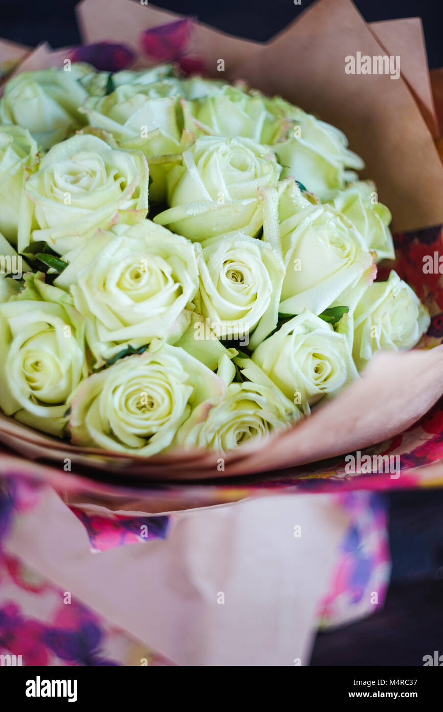 Beautiful bouquet with fresh white roses on a table with copyspace ...