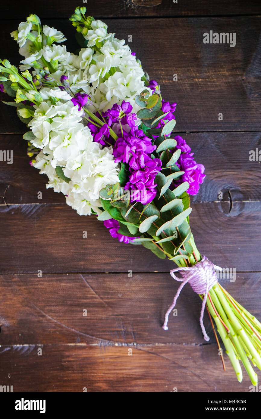 Beautiful bridal bouquet with fresh snap dragon flowers on wooden table ...
