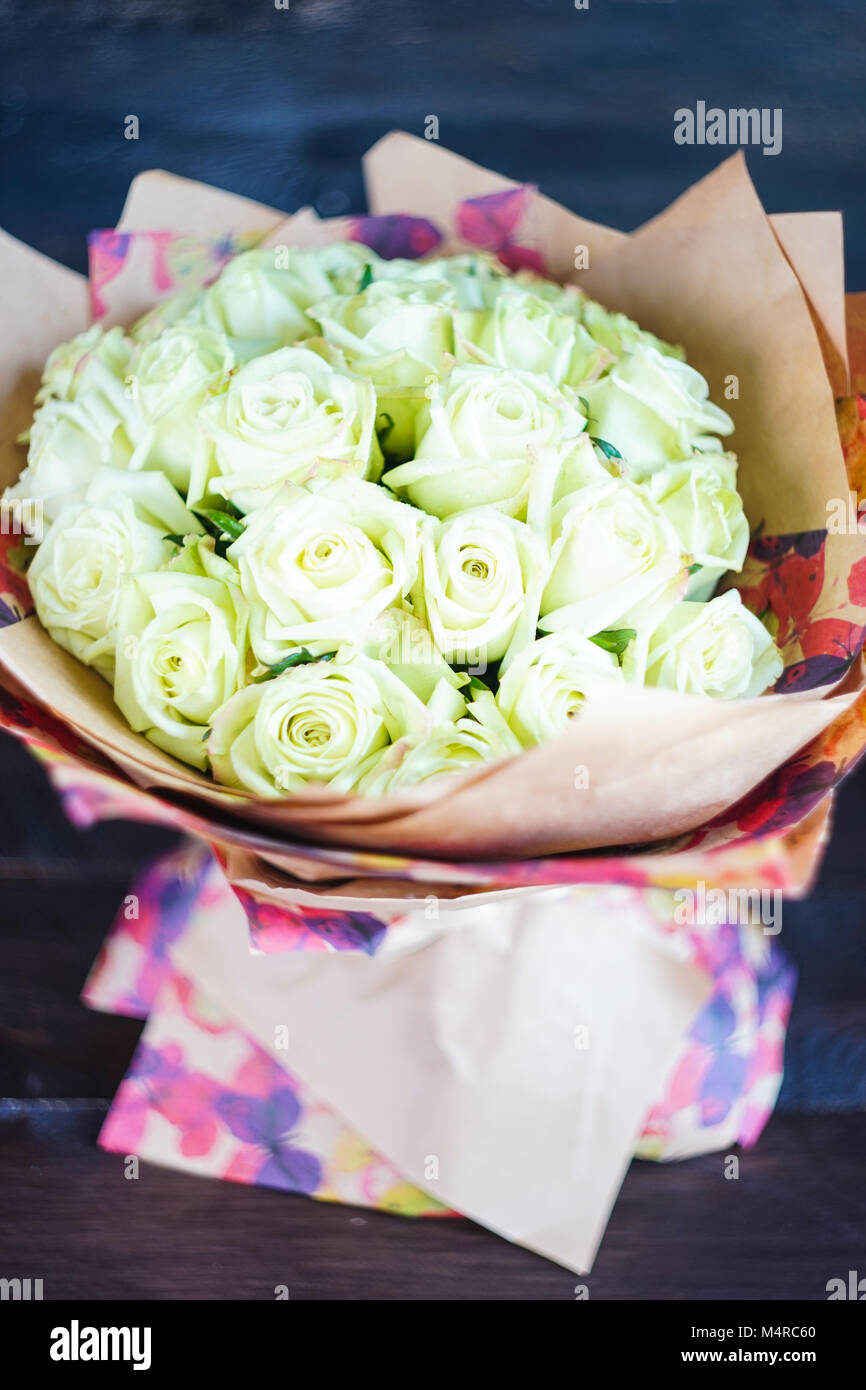 Beautiful bouquet with fresh white roses on a table with copyspace ...