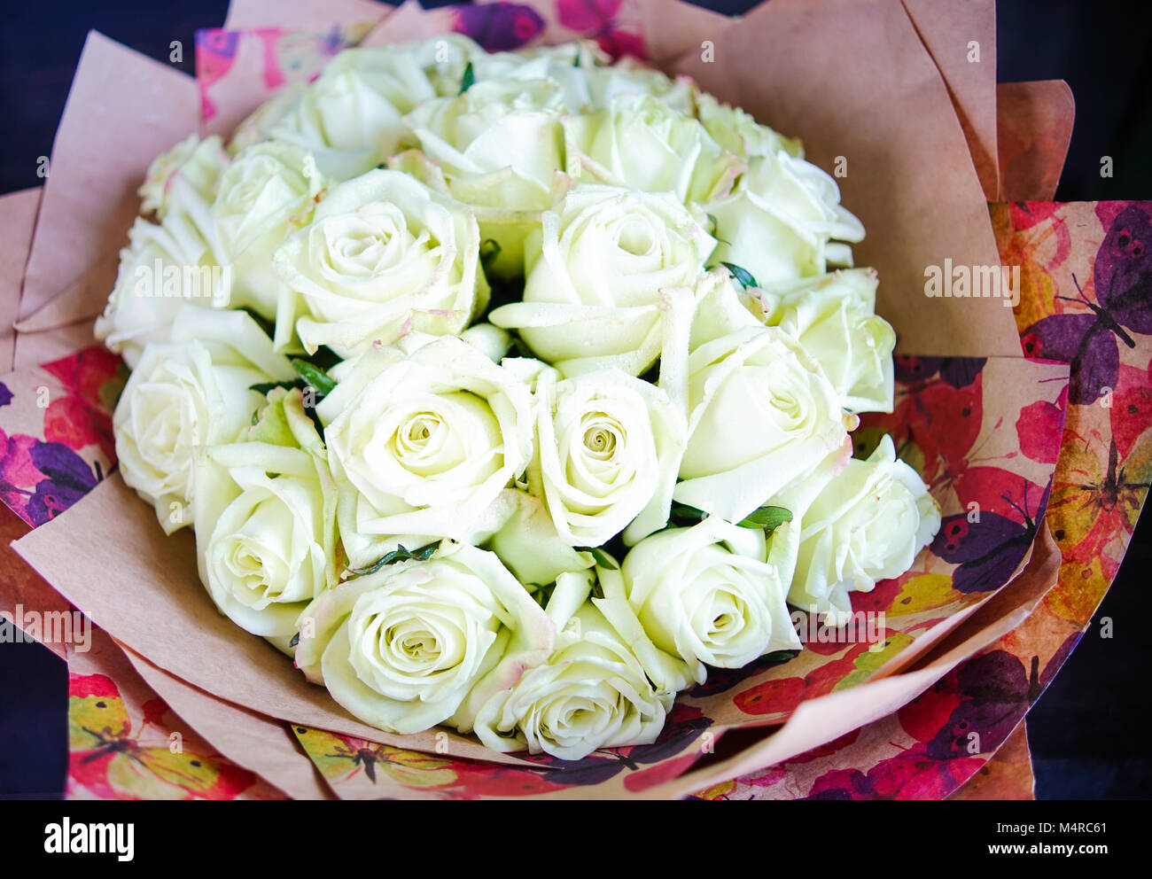 Beautiful bouquet with fresh white roses on a table with copyspace ...