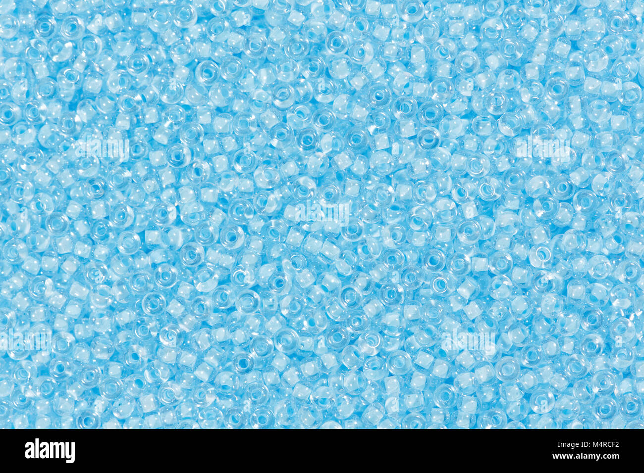 Small light blue beads background. Hi res texture Stock Photo - Alamy
