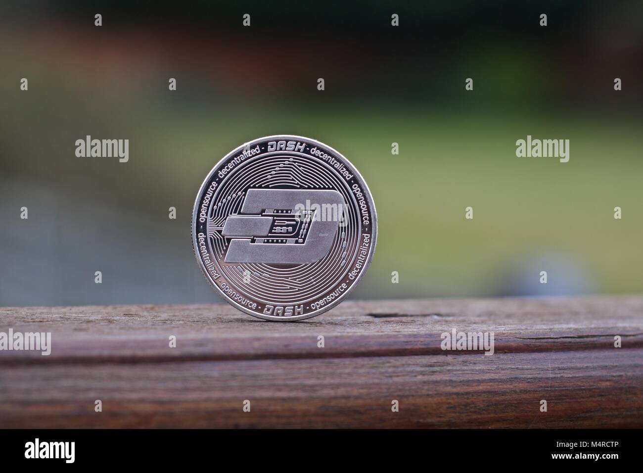 Digital currency physical metal silver dashcoin coin. Outdoor concept ...