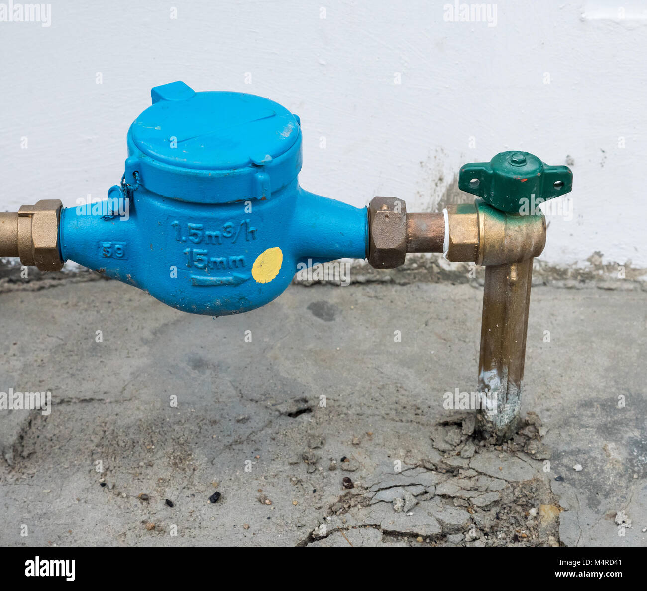 Closeup of the new water meter near the house wall in the urban area ...