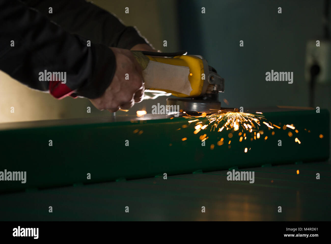 Manual labour - worker grinding the steel mechanism on the plant Stock ...