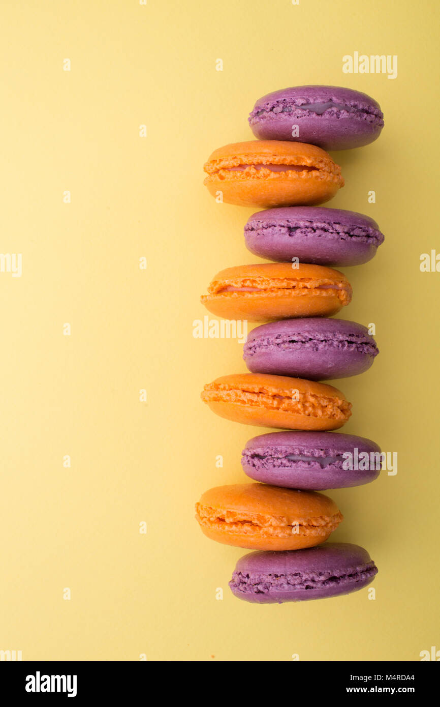 Top view of violet and pink macaron on the blue pastel color background ...