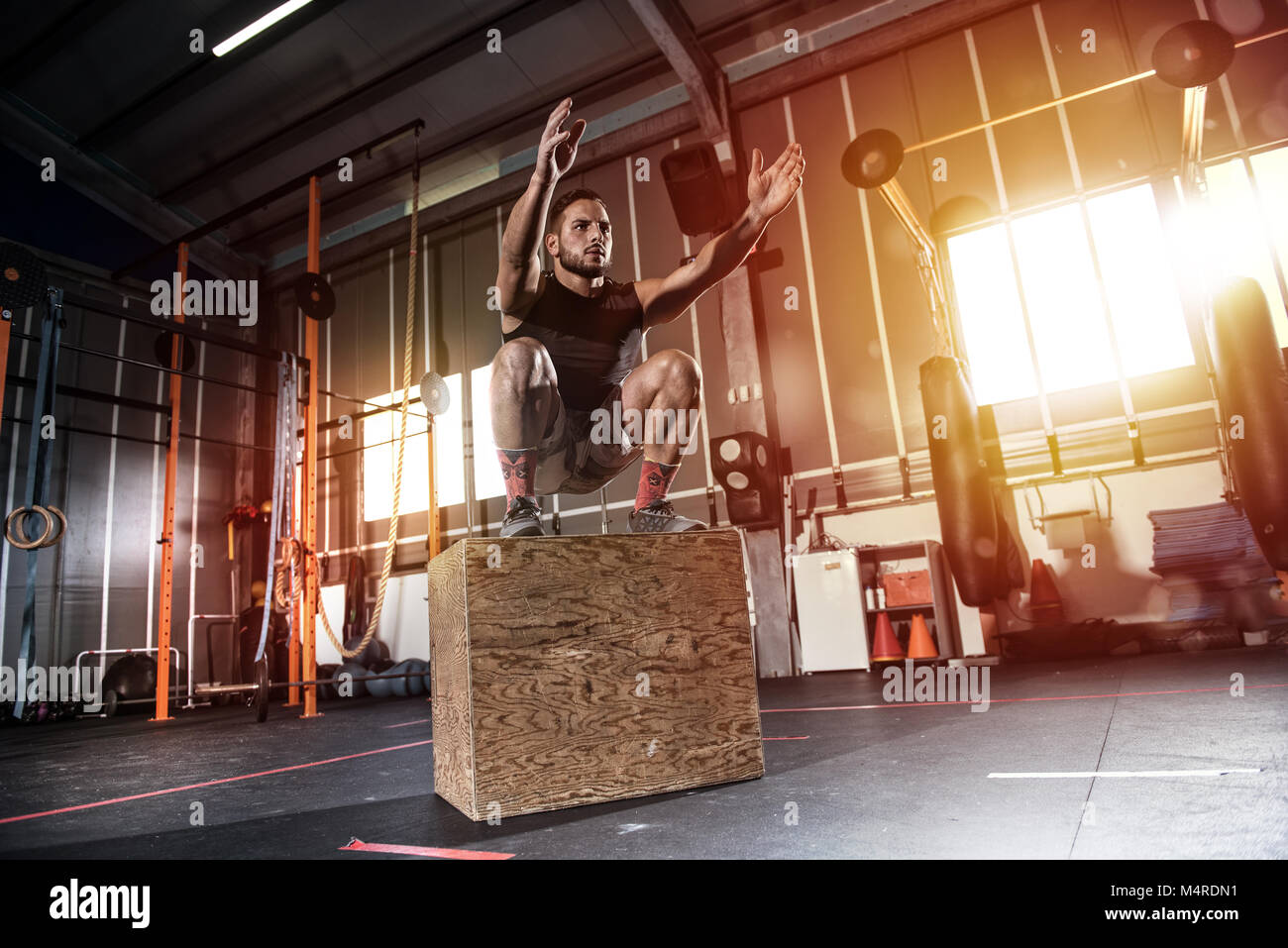 Athletic man does box jump exercises at the gym Stock Photo - Alamy