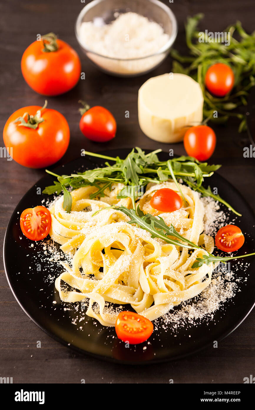 Delicious healthy italian pasta in black plates Stock Photo - Alamy