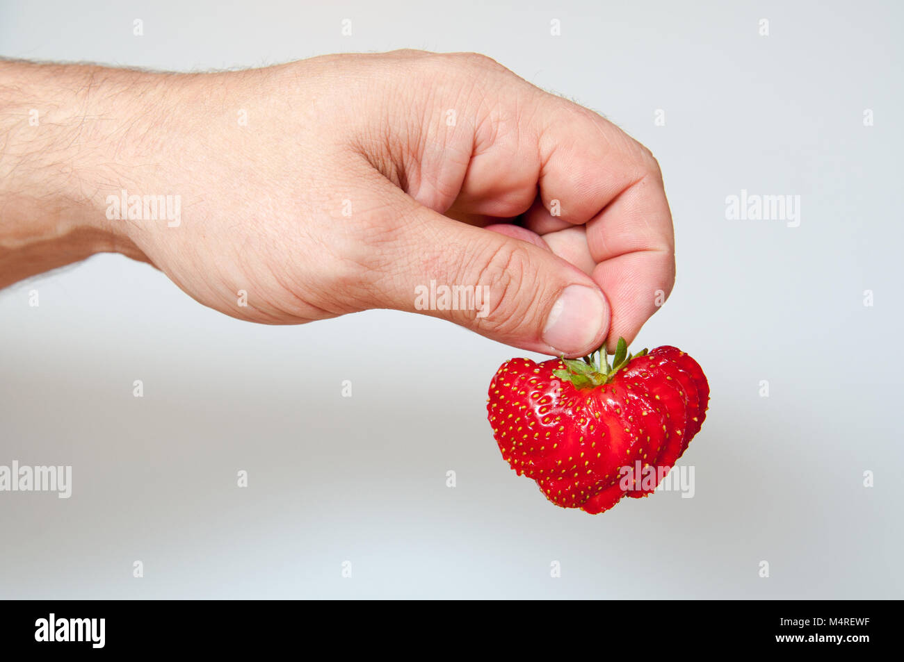 Strawberry in man hand Stock Photo - Alamy