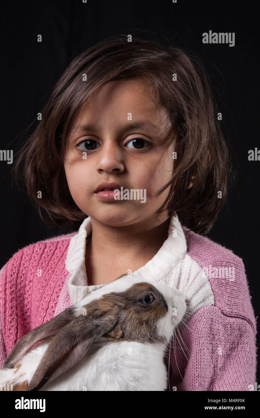 Pretty girl holding pet Rabbit Stock Photo - Alamy