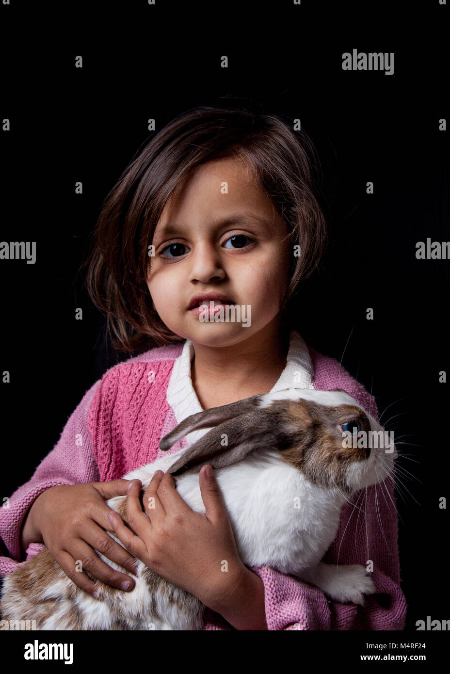 Pretty girl holding pet Rabbit Stock Photo - Alamy