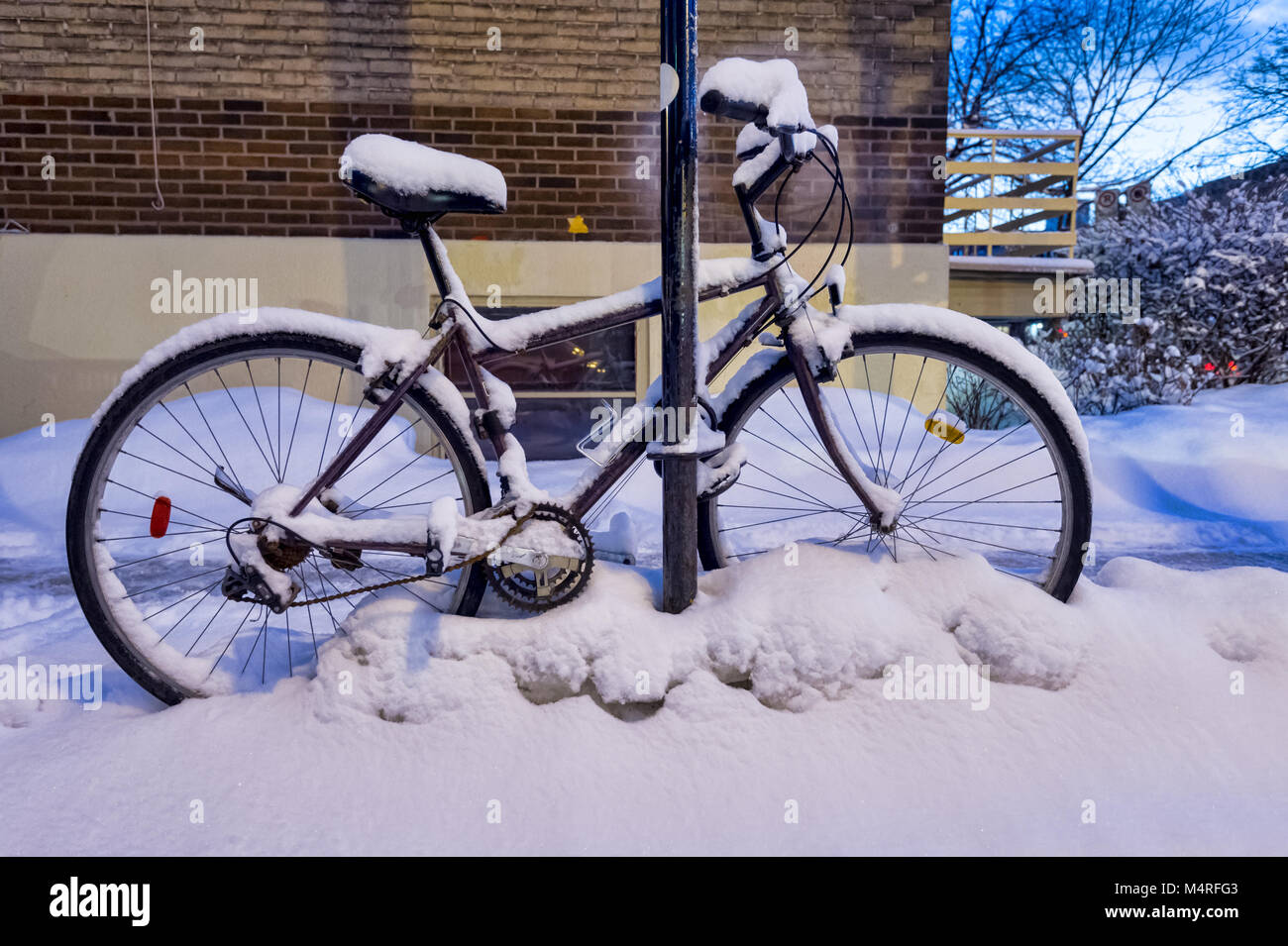 Bike covered in snow during snow storm Stock Photo - Alamy