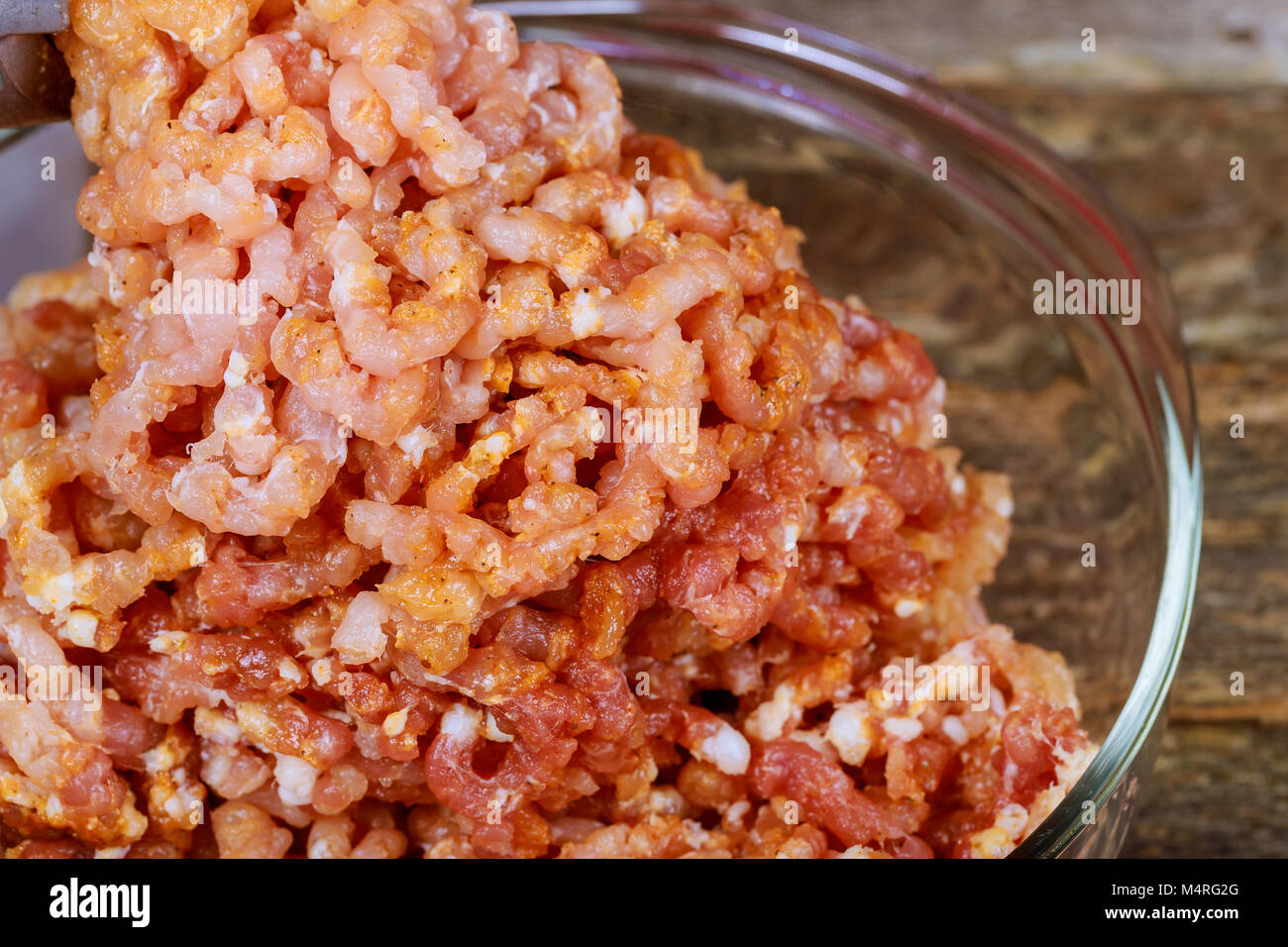Mincer and a pile of chopped meat preparated of meat. Cooking minced ...