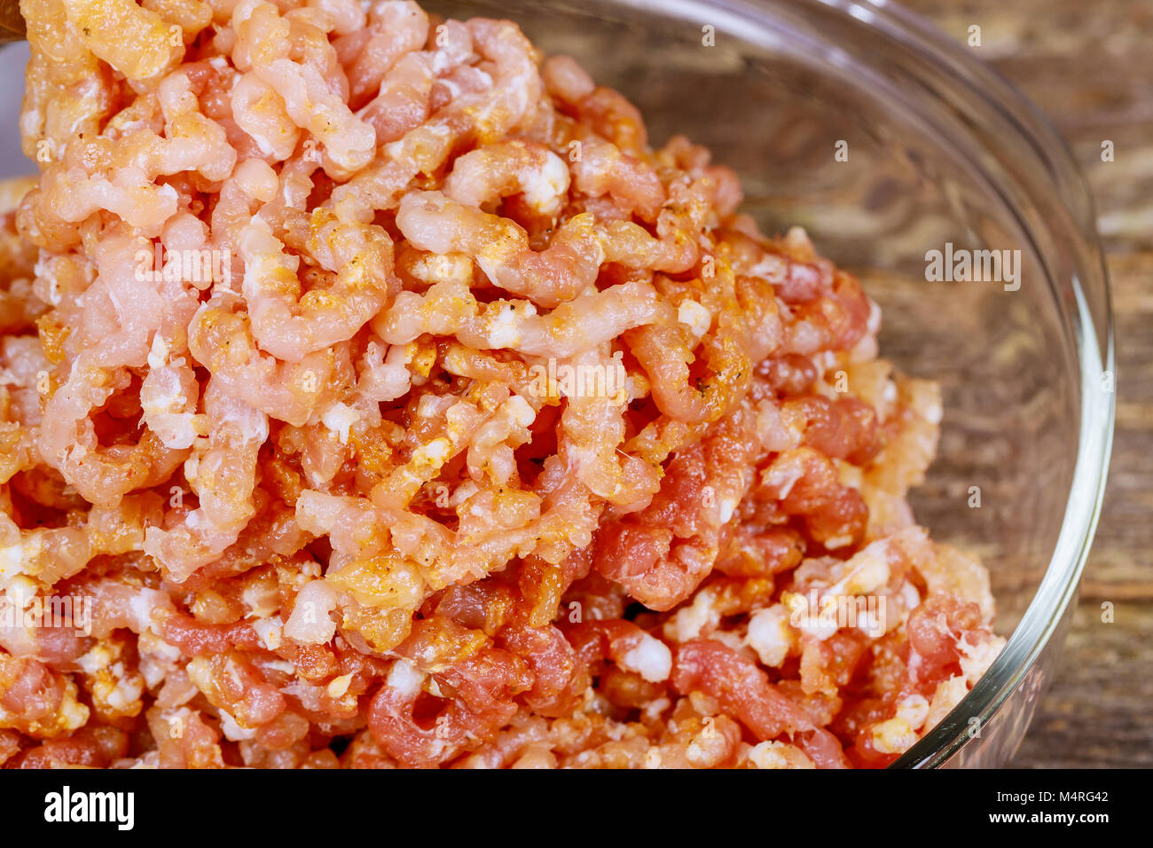 Closeup of minced meat coming out from grinder in preparation of minced ...