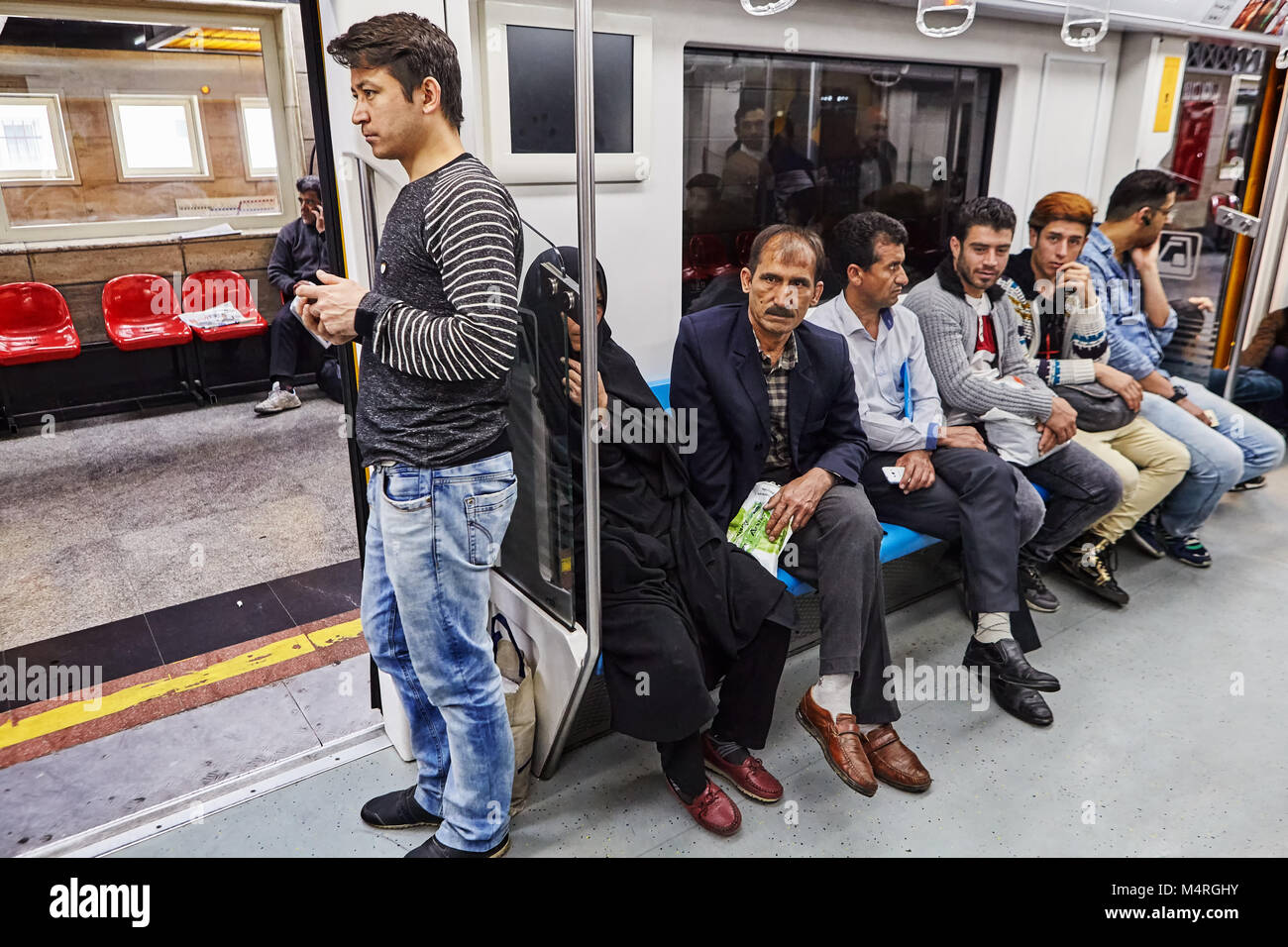 Tehran, Iran - April 29, 2017: Several men and one woman are sitting in ...
