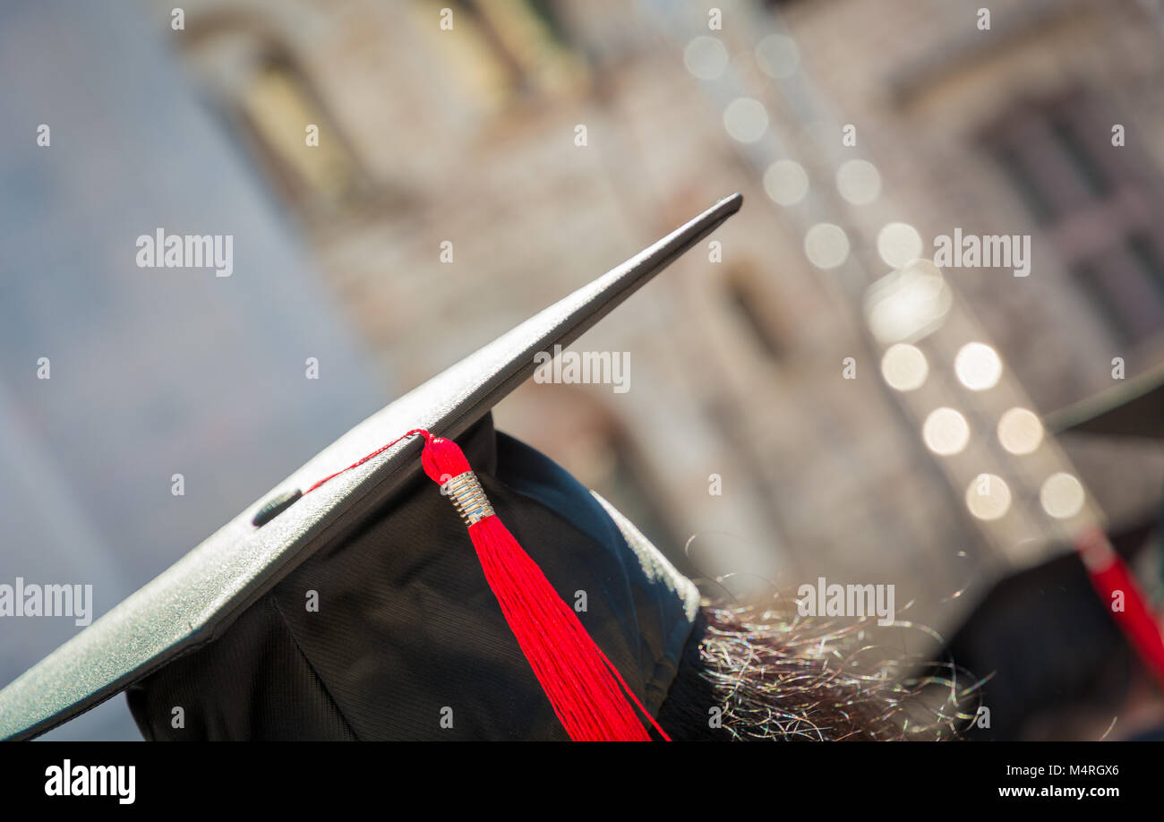 Back of graduate during the graduation ceremony. Close up at graduate ...