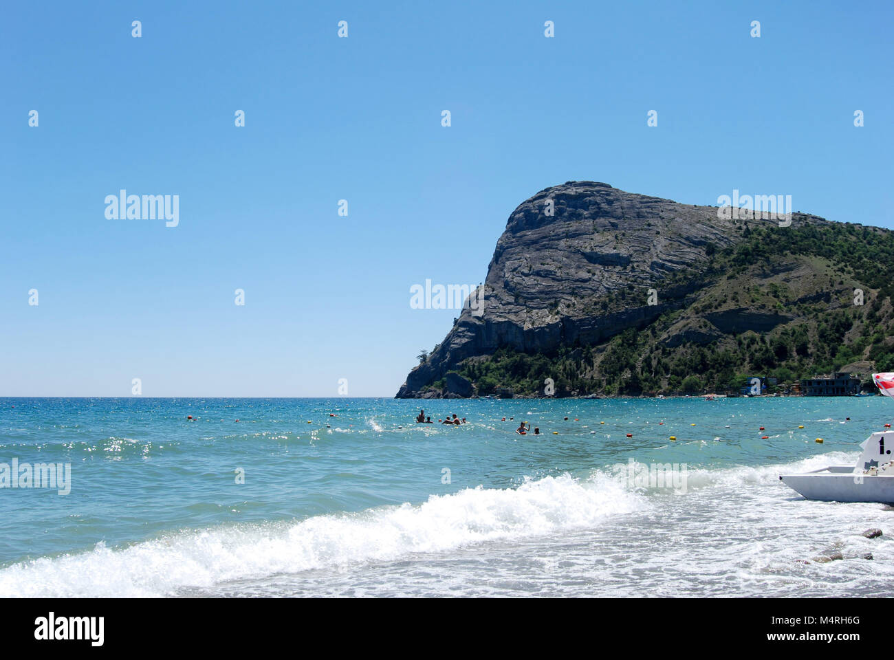 People swimming next to the mountain at the Crimean Novyi Svit - Новый ...