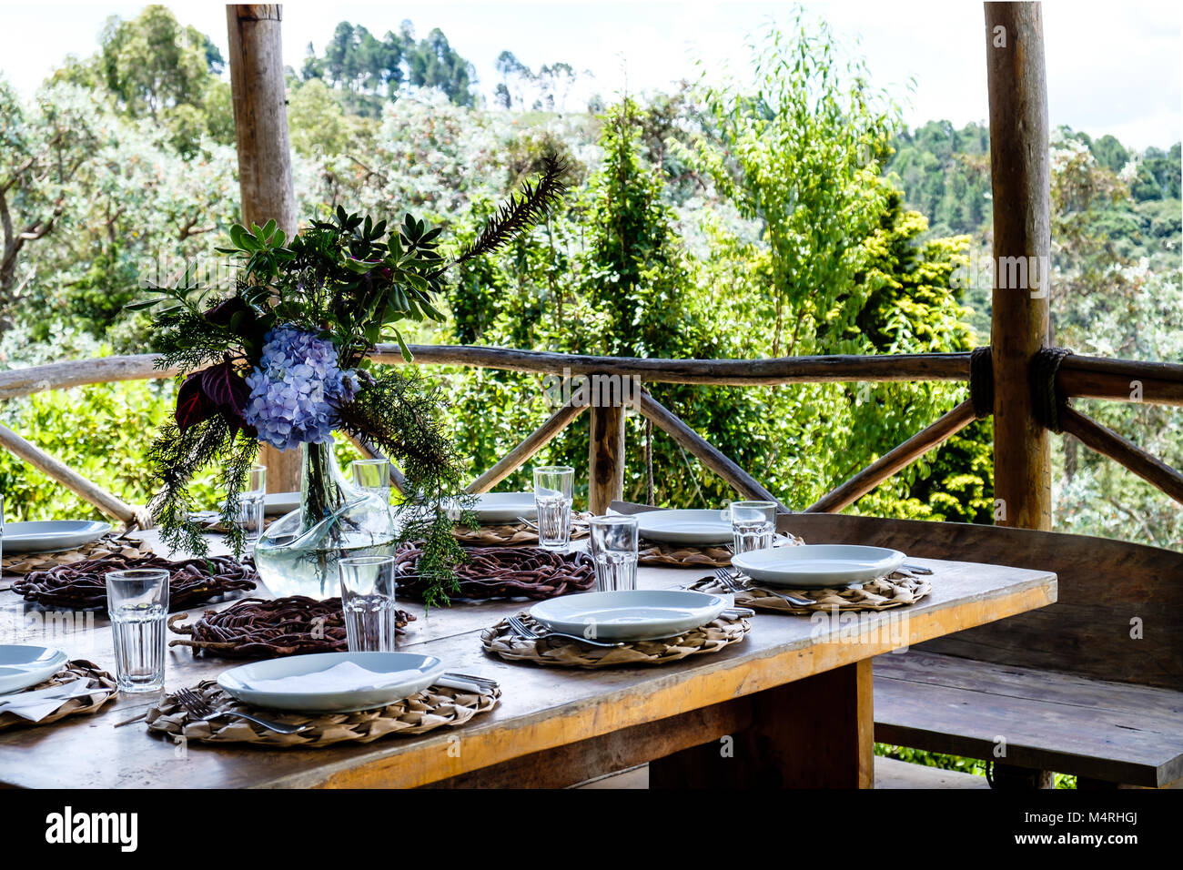 Table set for lunch in an outside hut with beatiful views to the forest ...