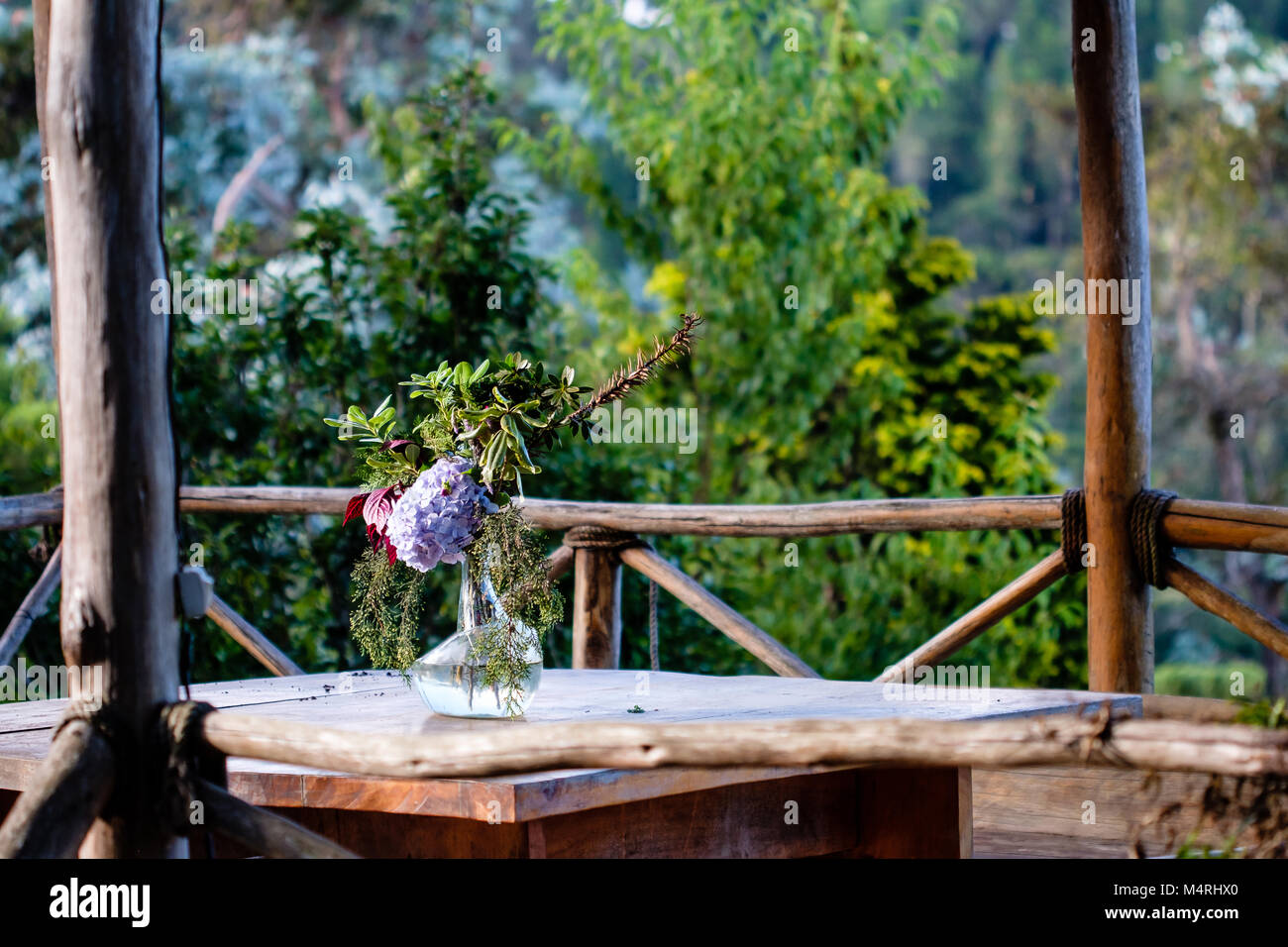 Table set for lunch in an outside hut with beatiful views to the forest ...