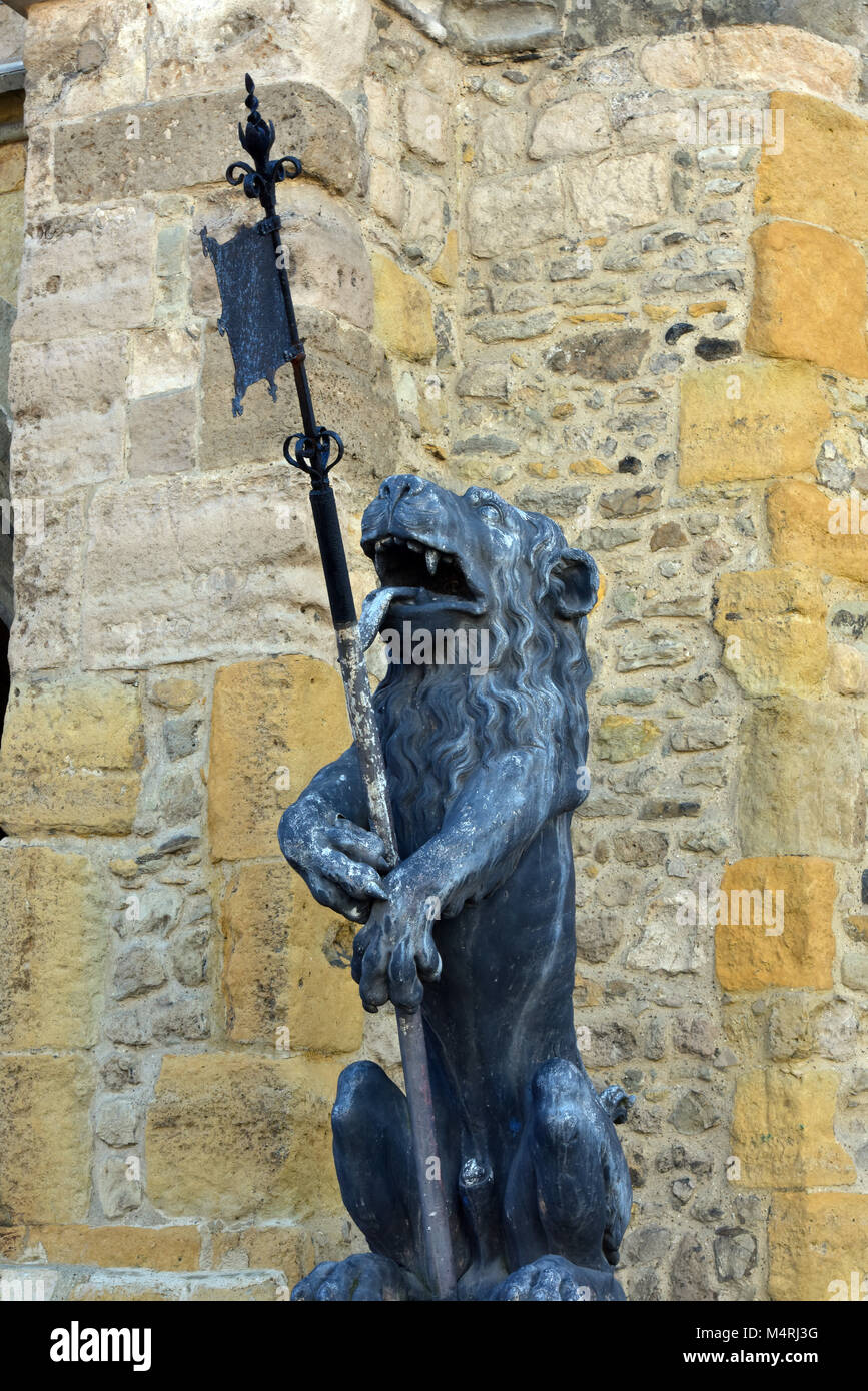 a statue of a lion rampant bearing or holing a halberd, pike or banner ...