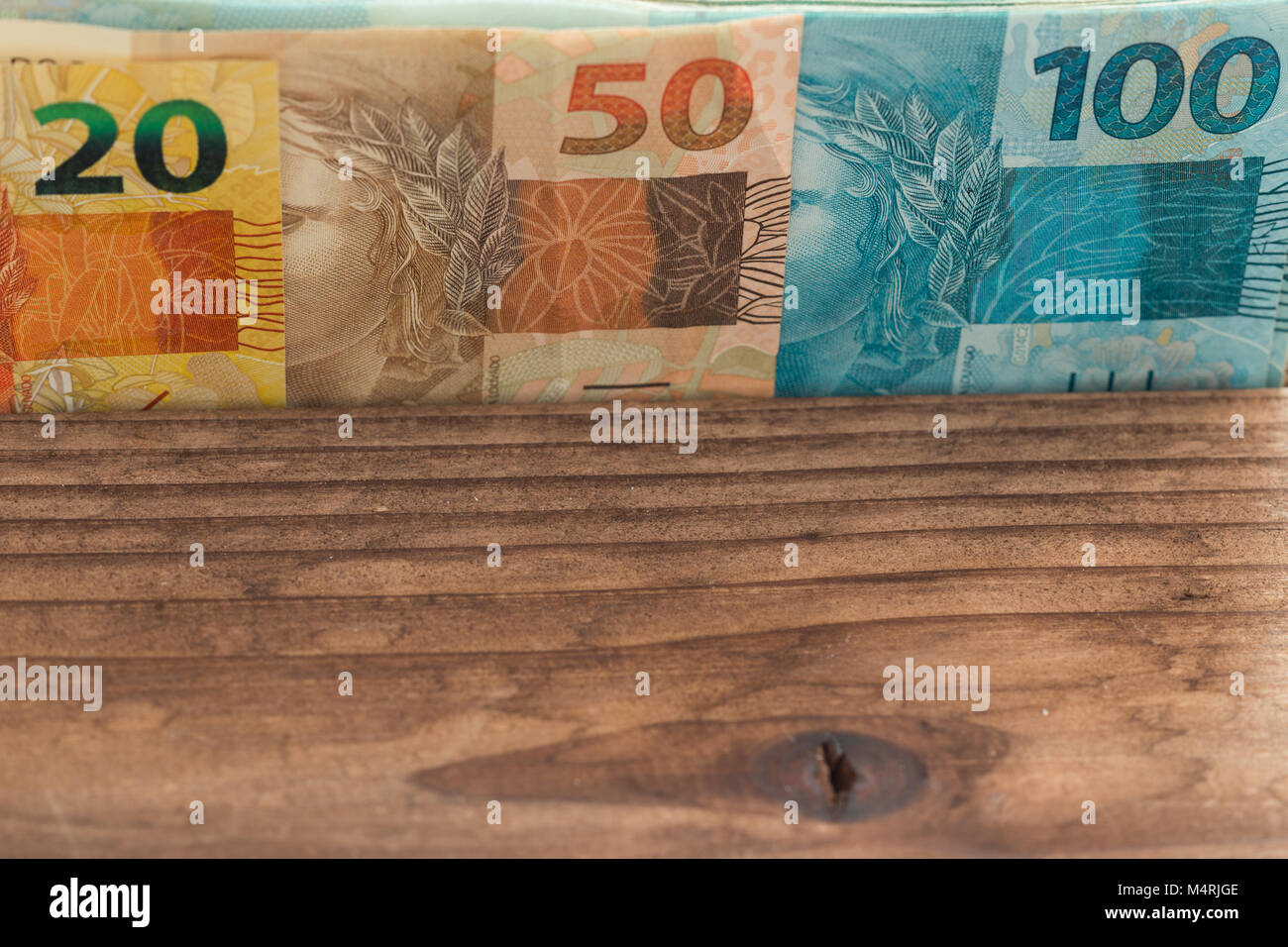 brazilian money all denominations on the wooden background with place ...