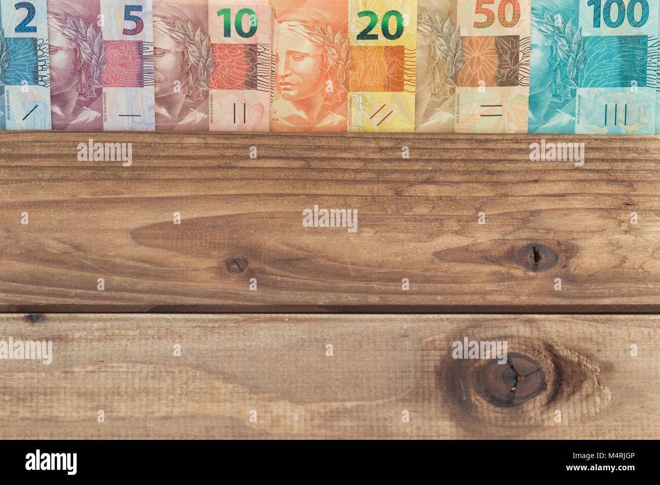 brazilian money all denominations on the wooden background with place ...