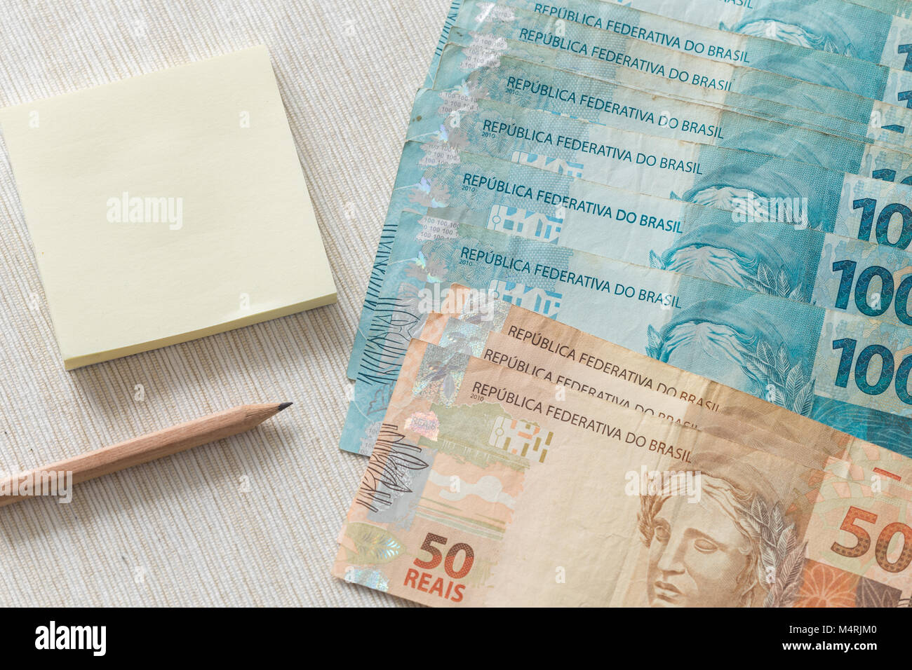 Brazilian money with a pencil and a piece of paper with space for an ...