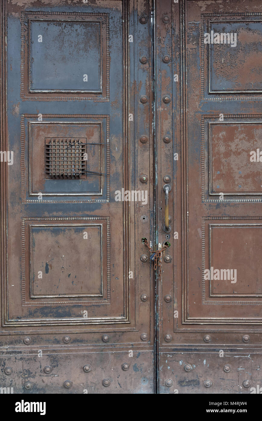 a very large pair of heavy wooden doors on an old or historic building ...