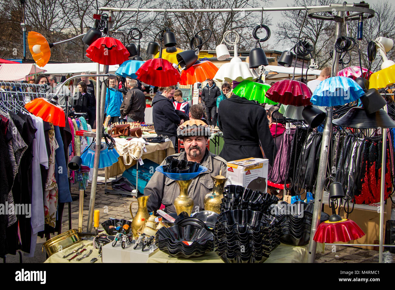 Funny shopkeeper among his colorful lampshades at the Mauerpark sunday ...