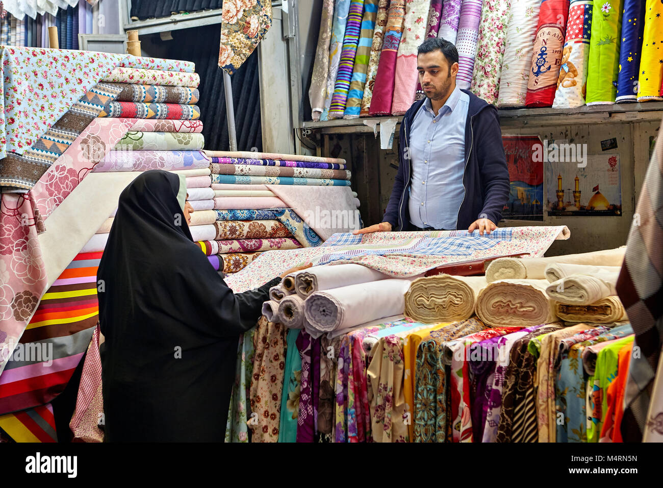 Tehran, Iran - April 29, 2017: Iranian man sells textile to woman in ...