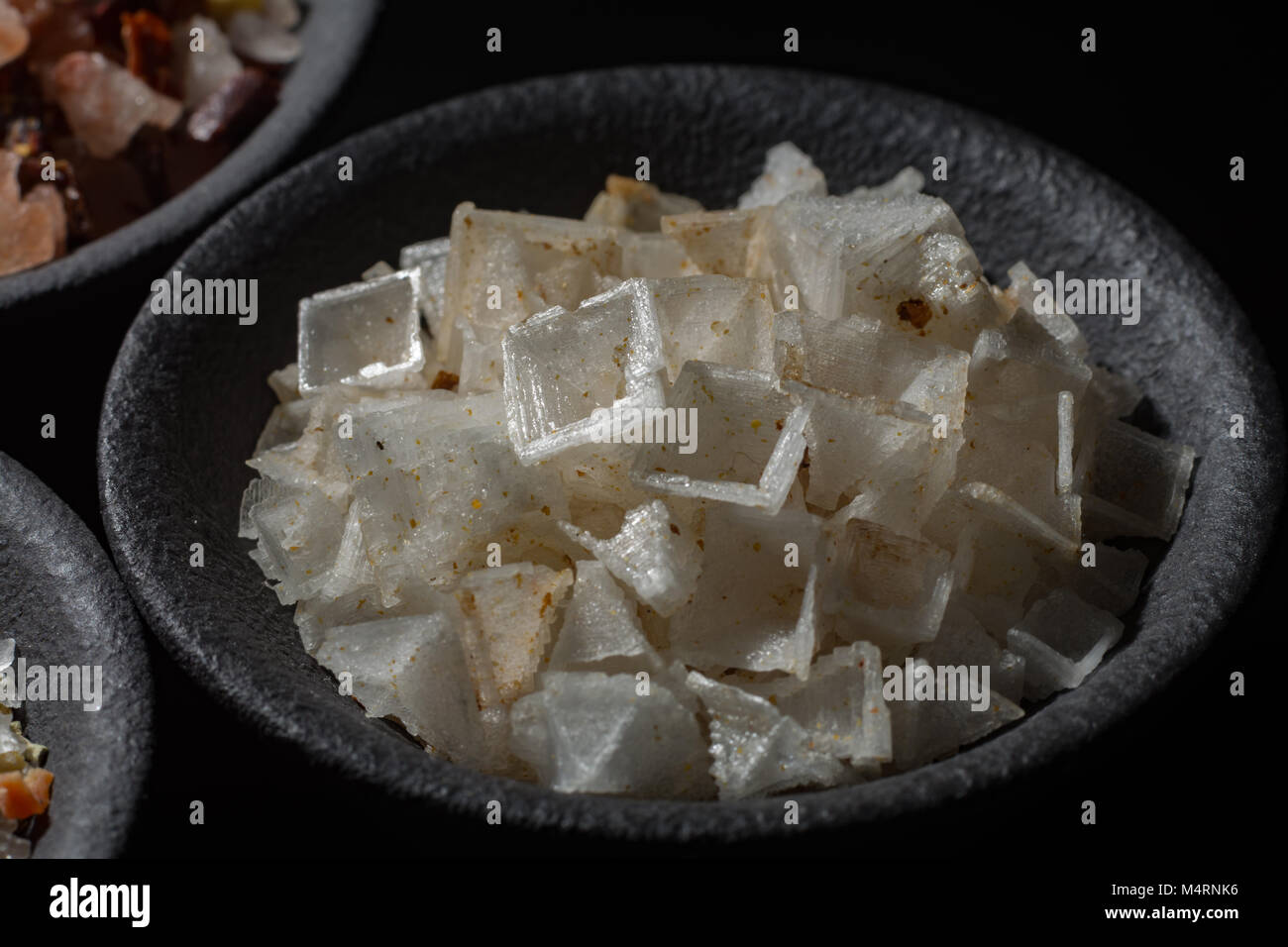 Macro collection, white sea salt pyramide flakes mixed with spices on ...