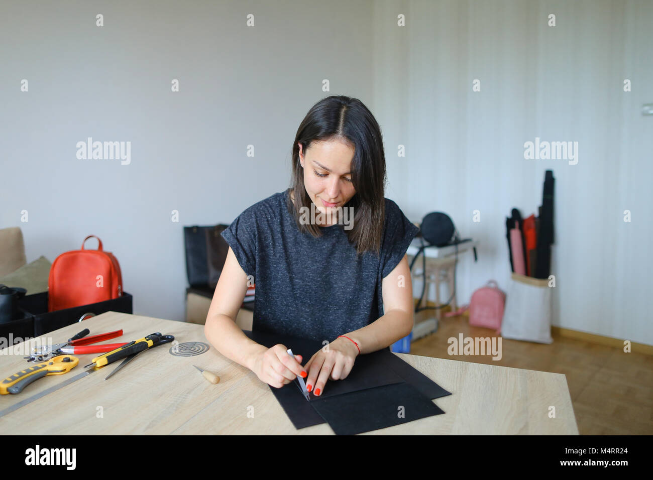Young woman making bag at sewing circle Stock Photo - Alamy