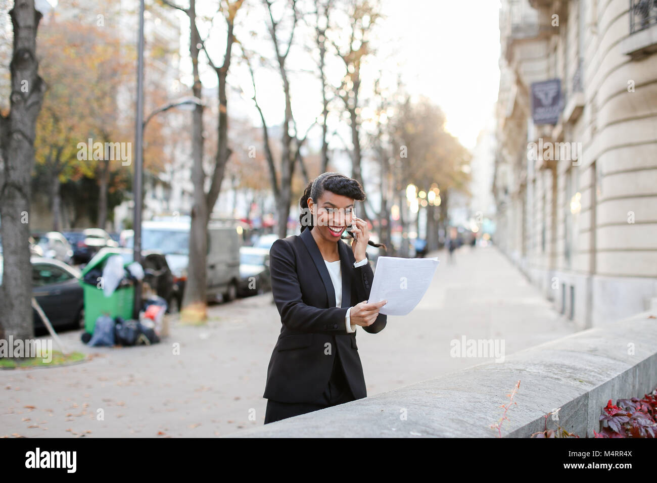 Accountant standing on street with papers in hands and talking o Stock ...