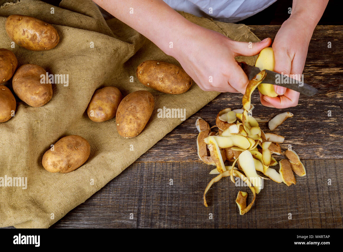 Woman peeling potatoes knife home hi-res stock photography and images ...